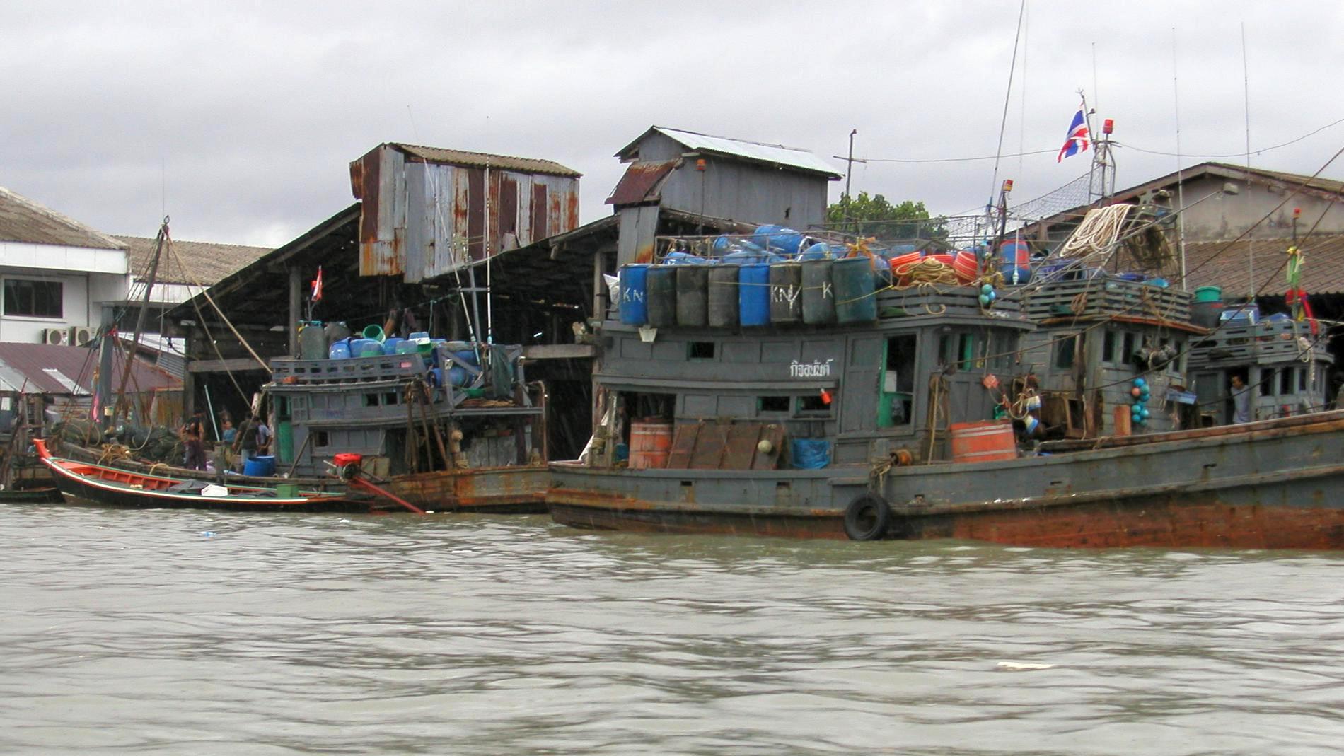 Leaving the Ranong bay past old tugs.